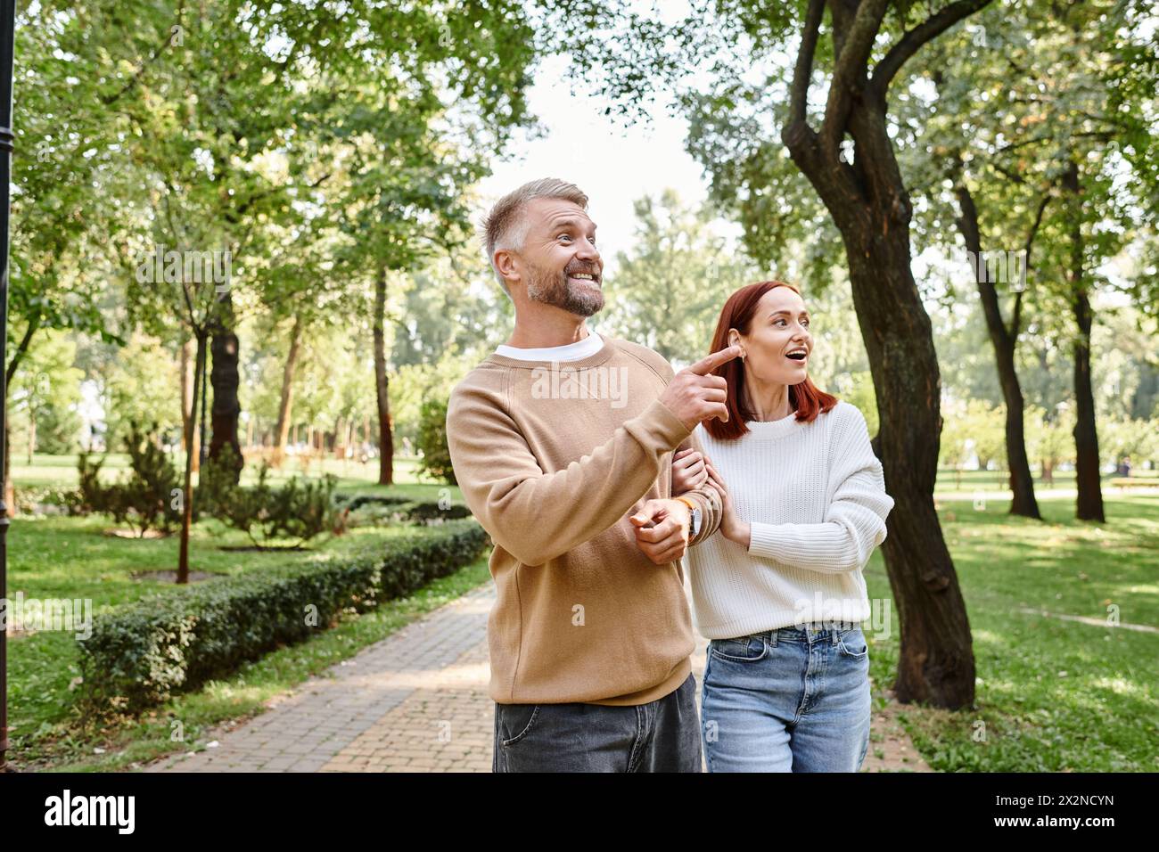 A couple, casually dressed, enjoy a leisurely walk through a scenic ...