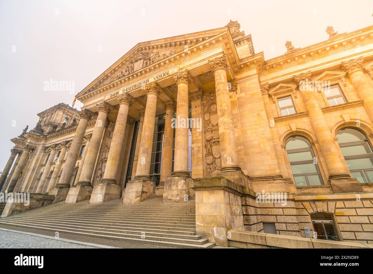 The Reichstag Building bathes in the warm glow of the setting sun ...