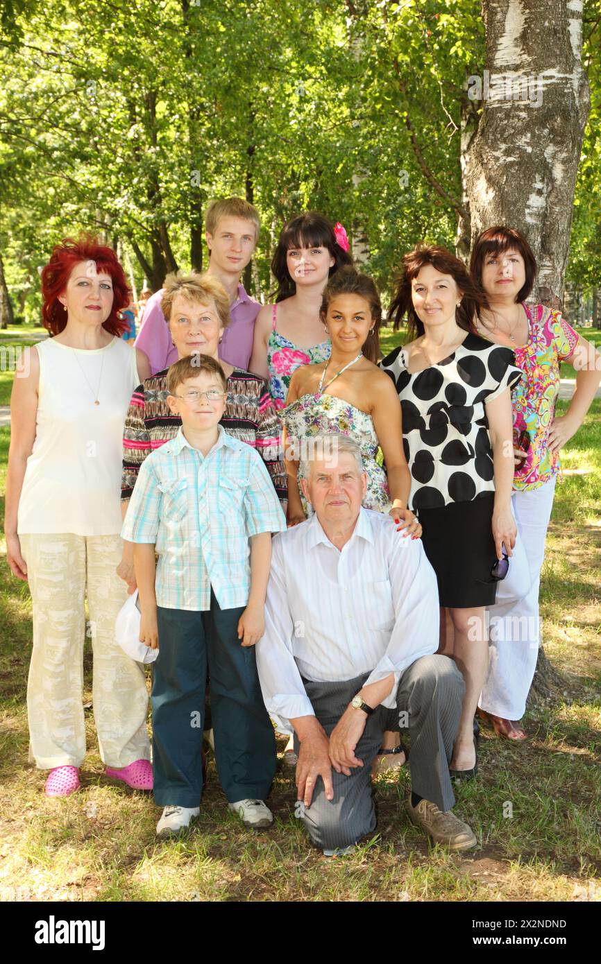 Big family of eight people pose at park Stock Photo - Alamy