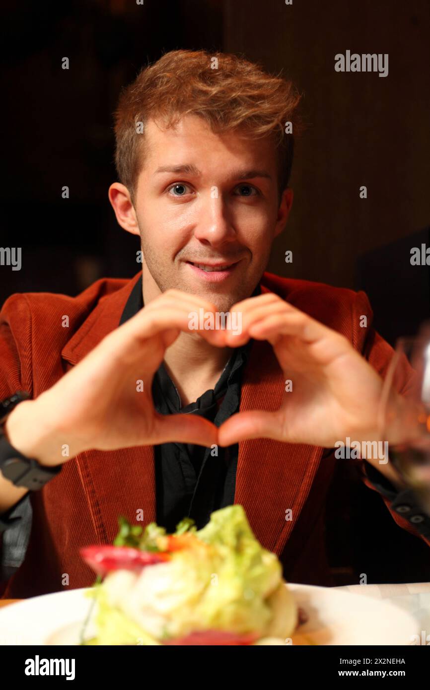Happy young man with his hands depicting heart Stock Photo - Alamy