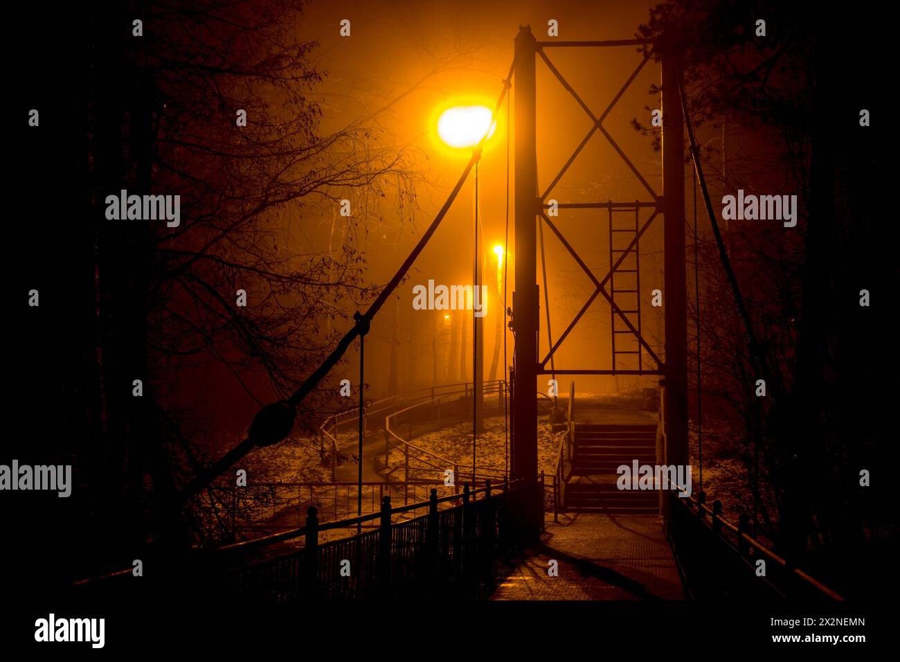 Pedestrian bridge in dense fog at night, foggy evening Stock Photo - Alamy