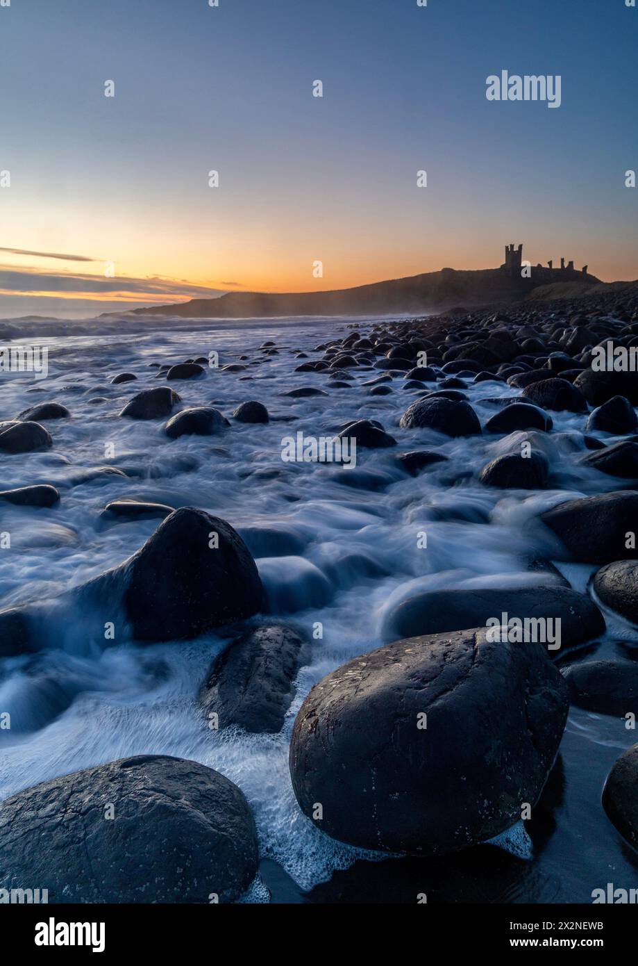 Boulder Beach and Dunstanburgh before Sunrise Stock Photo - Alamy