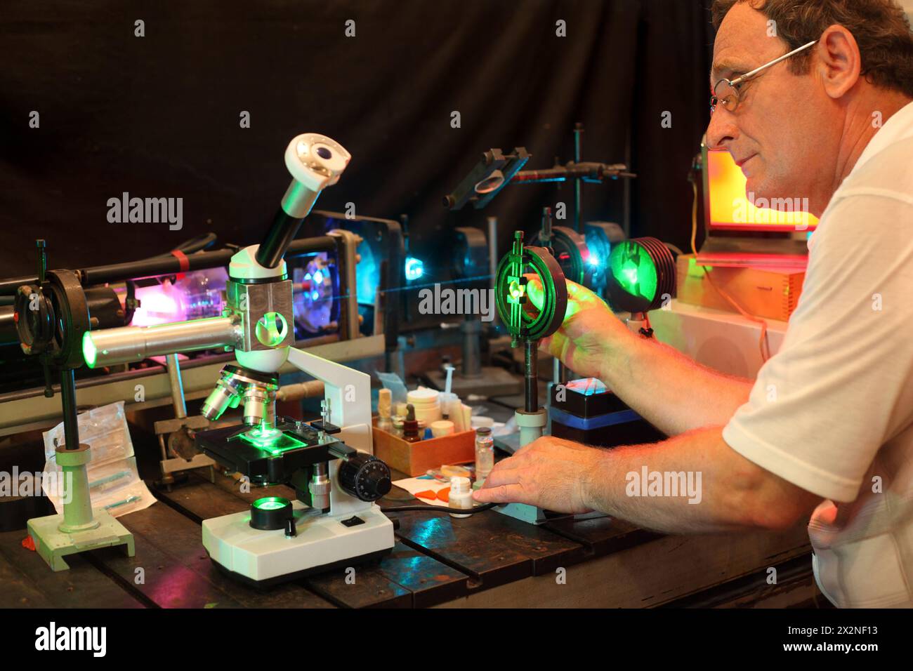 Scientist with glass demonstrate laser of microparticles Stock Photo ...
