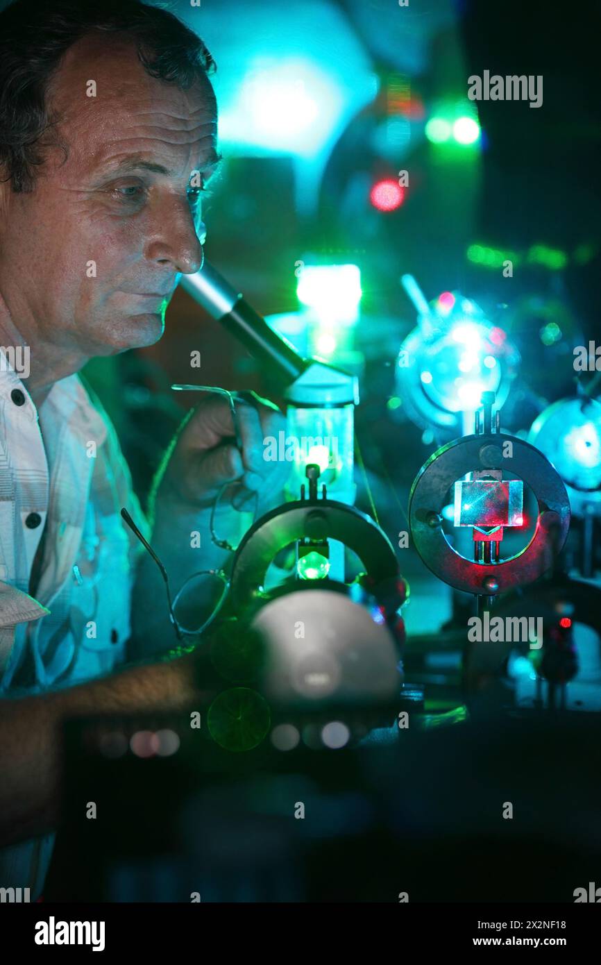 Scientist hold glasses in hand and engaged in research in his lab show ...