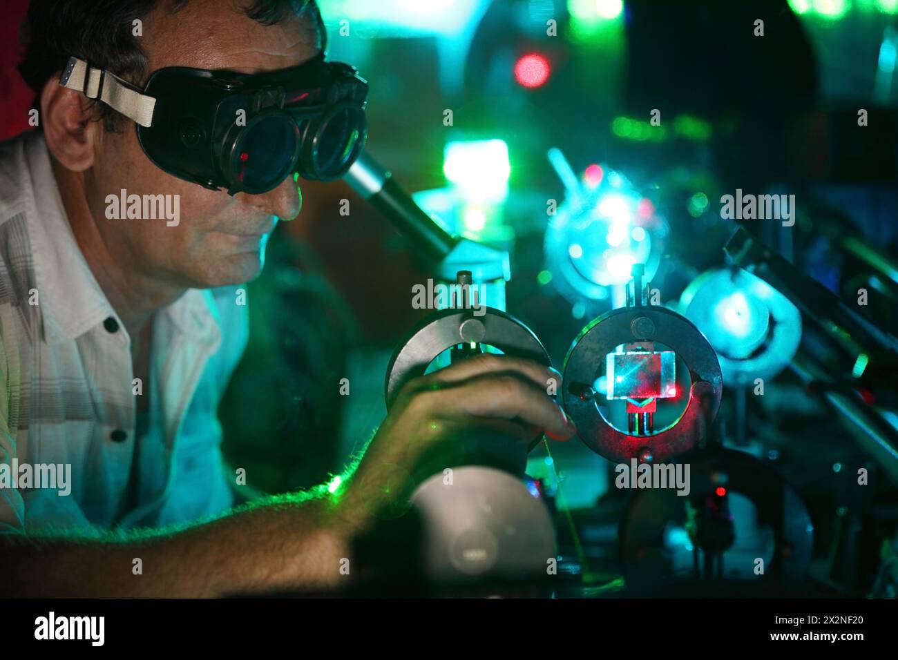 Scientist in laser vision glasses engaged in research in his lab show ...