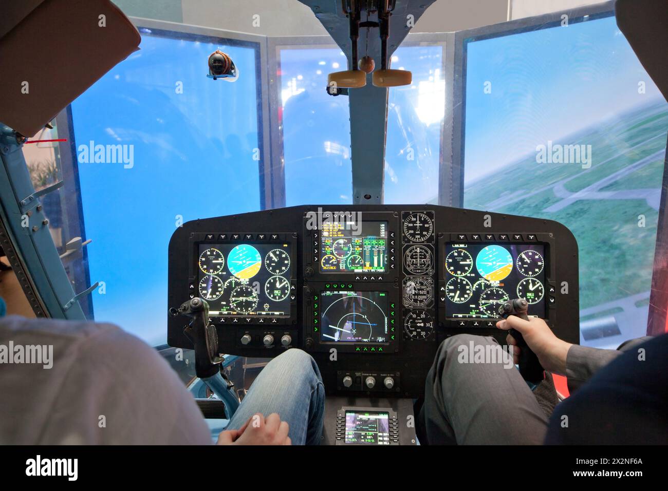 Two guys flying on helicopter simulator Stock Photo - Alamy