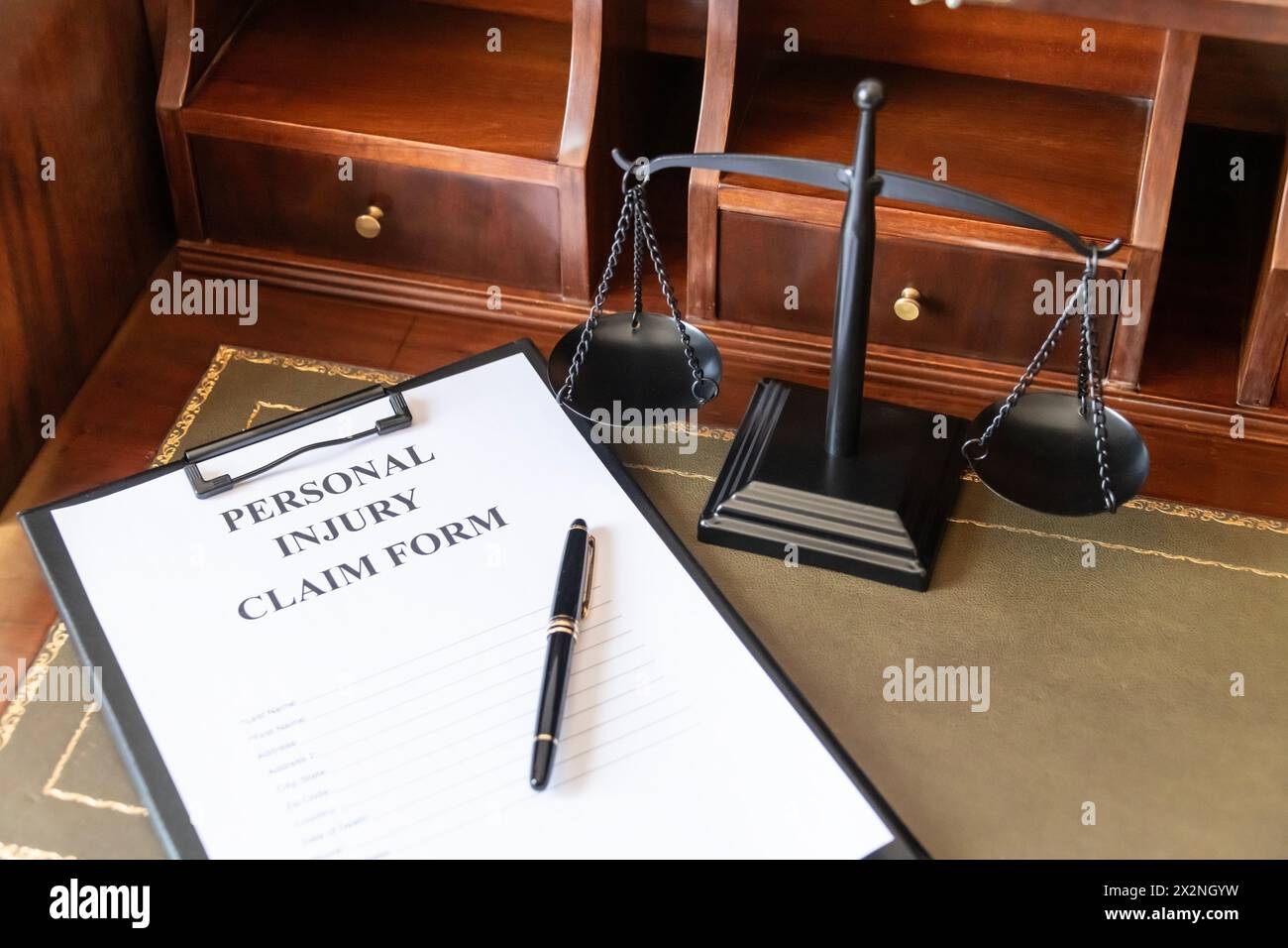 Legal Personal Injury Claim Form with Scales of Justice Stock Photo - Alamy