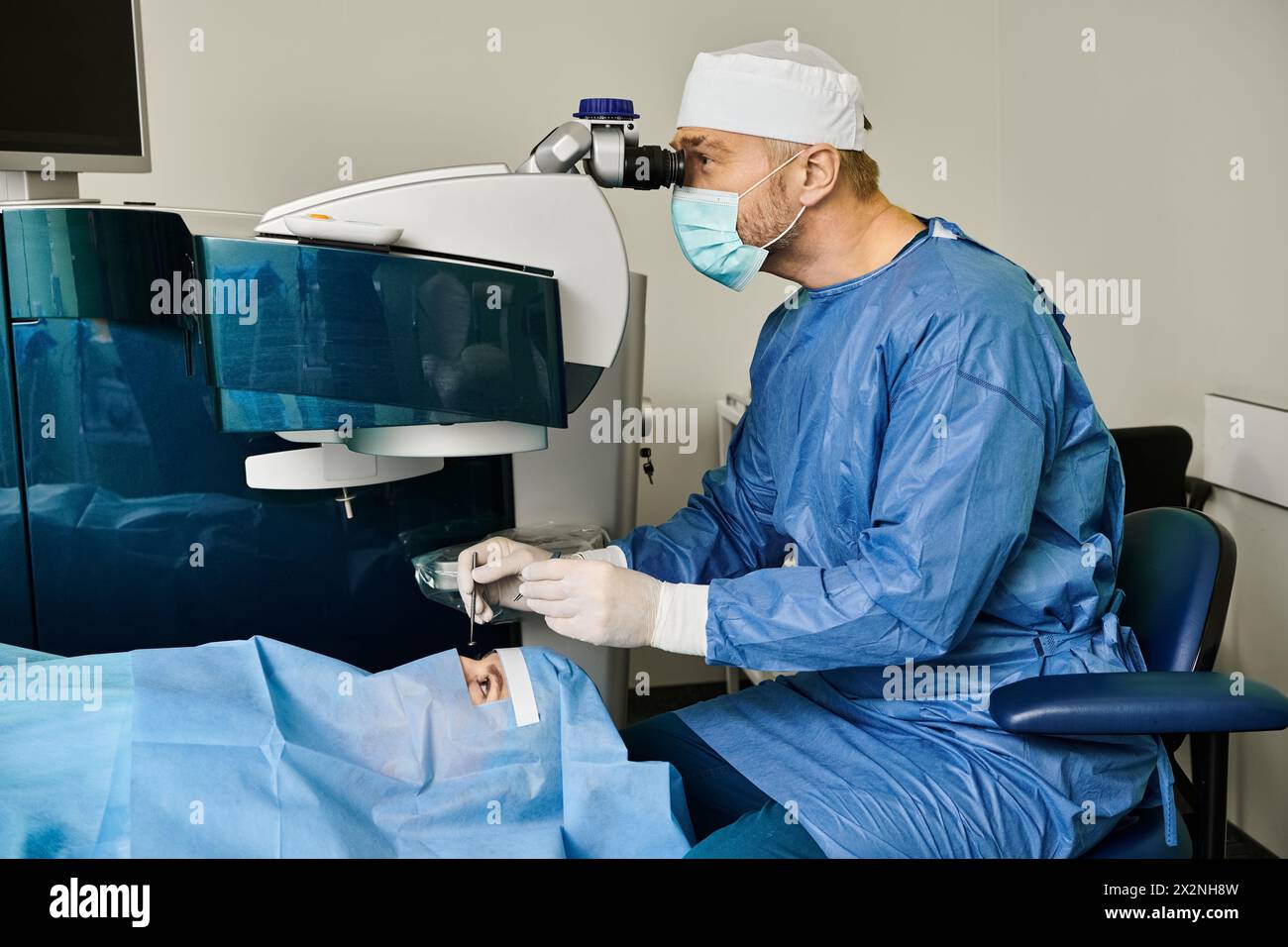 A surgeon in a gown and mask operates a machine Stock Photo - Alamy