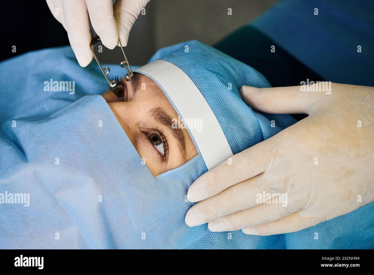 Devoted doctor performing laser vision correction on womans face Stock ...