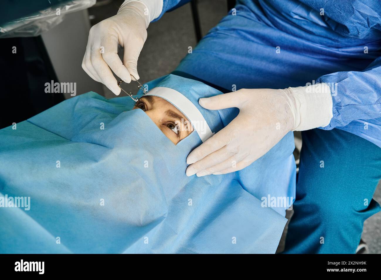 Dedicated doctor performing laser vision correction on womans face ...