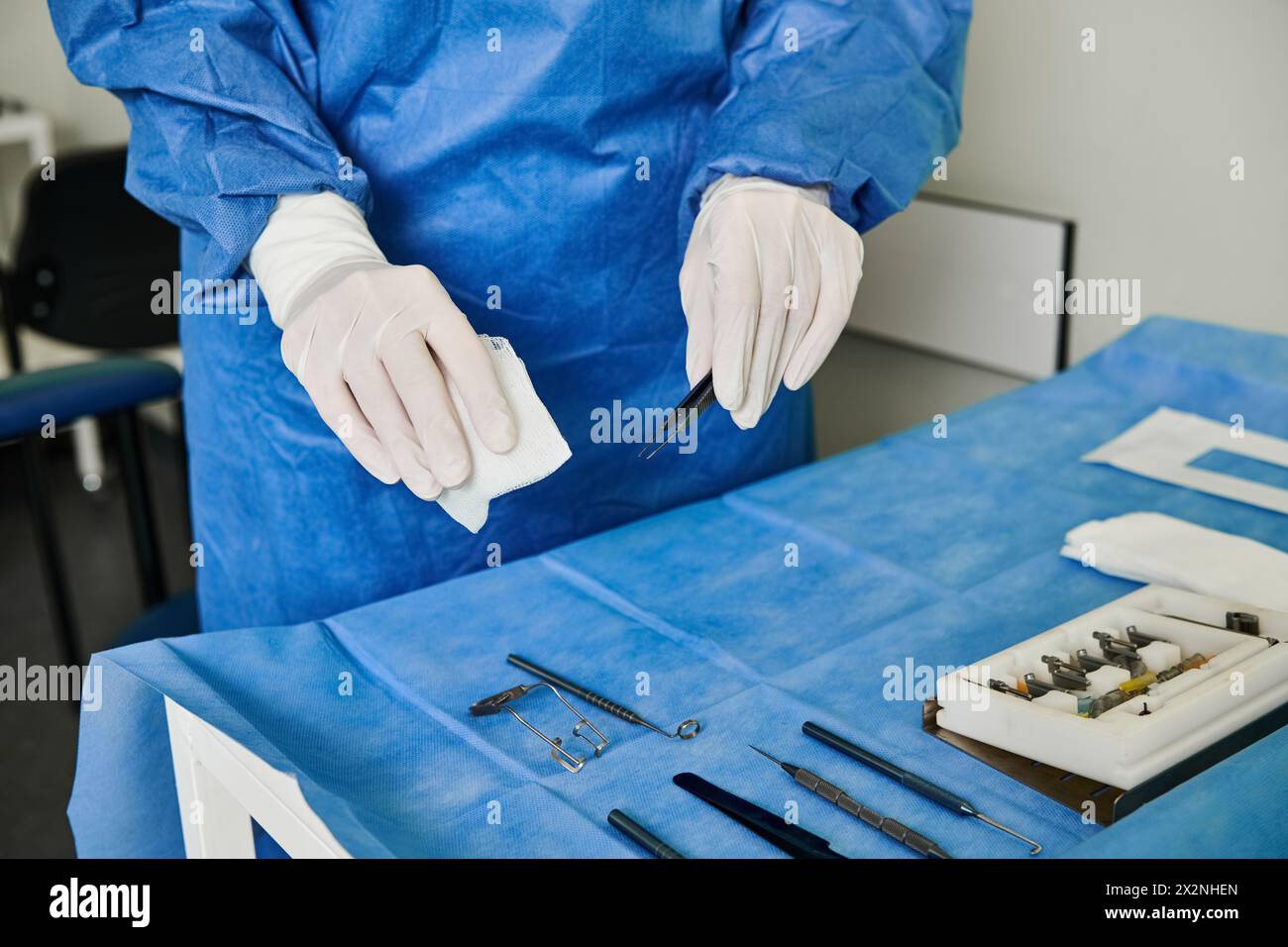 A person in a blue gown and white gloves at a laser vision correction ...