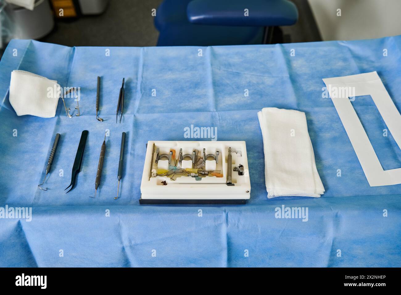 A table is set up with surgical equipment on top of a blue table cloth ...