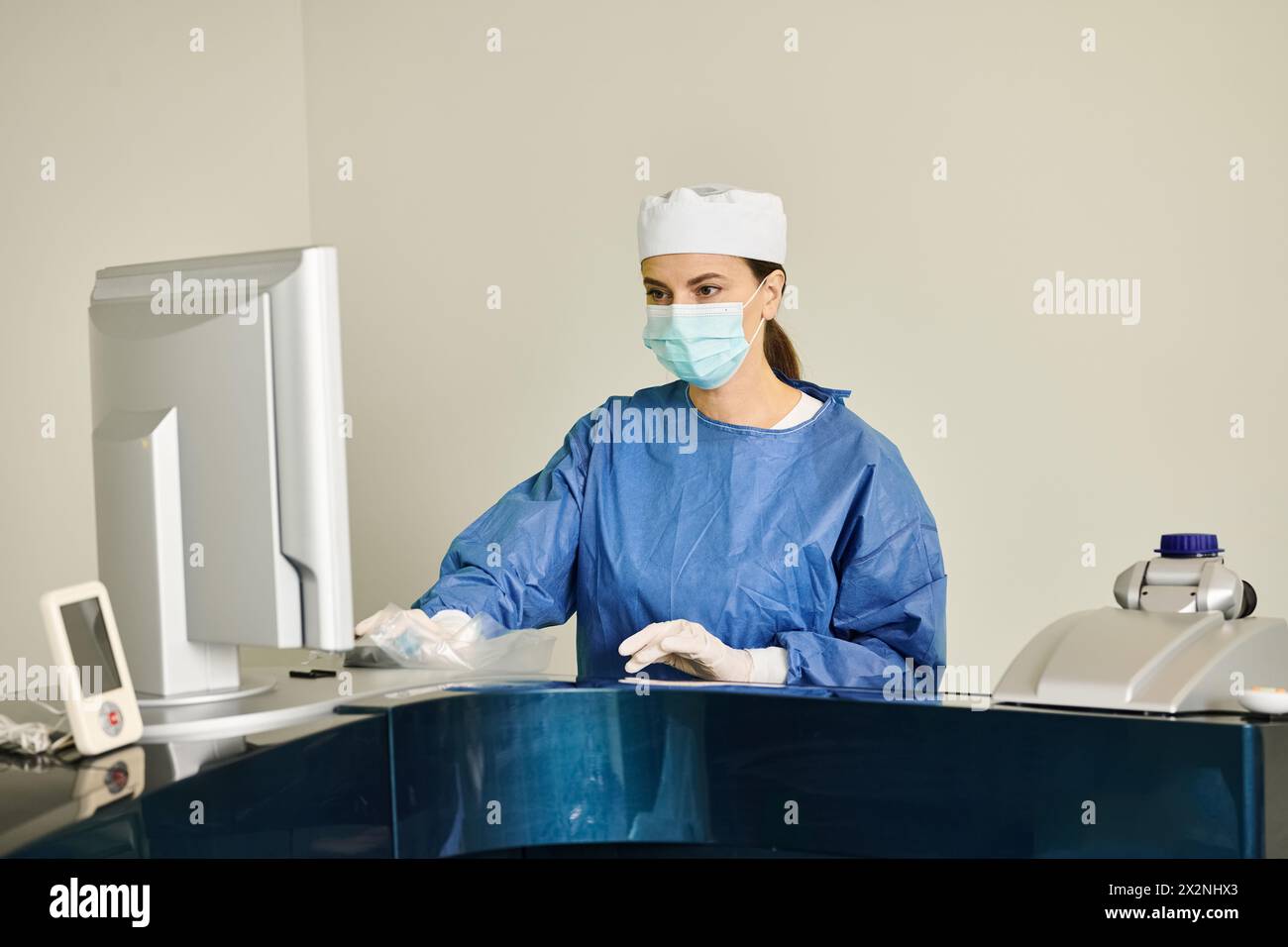 A woman wearing a surgical mask sits at a desk in a doctors office ...