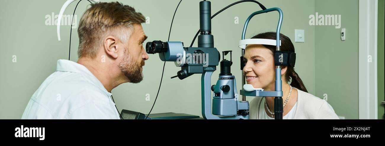 Good looking doctor checking his female patient vision Stock Photo - Alamy