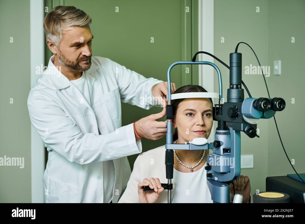 Bearded doctor checking his female patient vision Stock Photo - Alamy