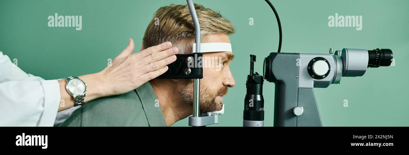 Devoted doctor examines mans eyes through a microscope in a doctors ...