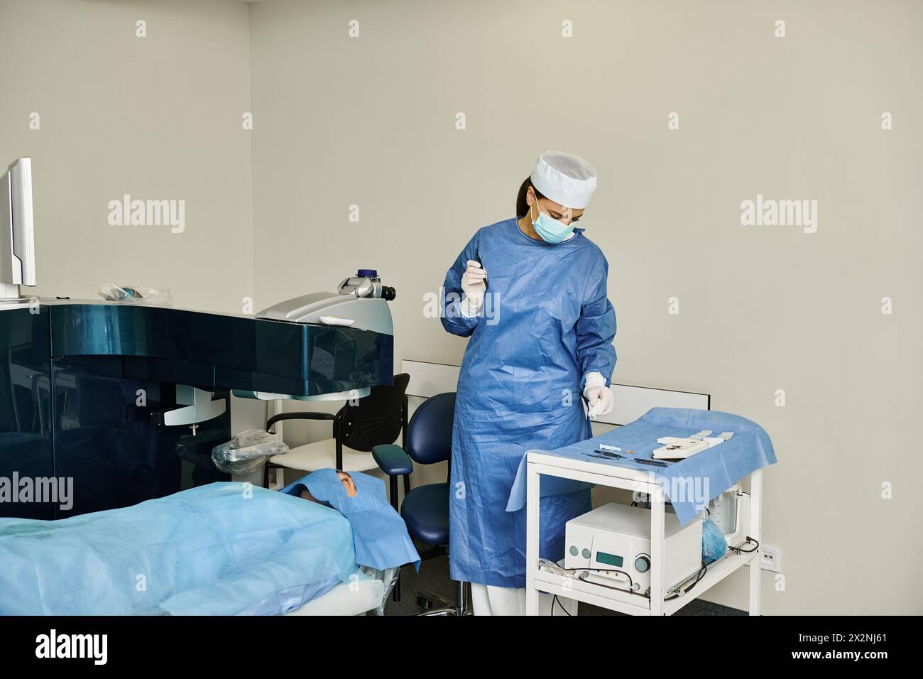 A person in a hospital room closely monitoring vital signs on a screen ...