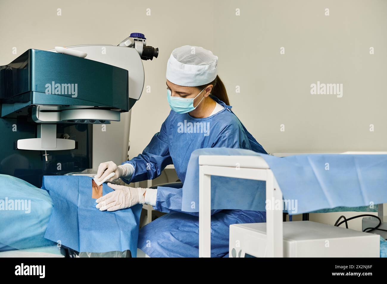 Woman in scrubs operates a machine for laser vision correction Stock ...