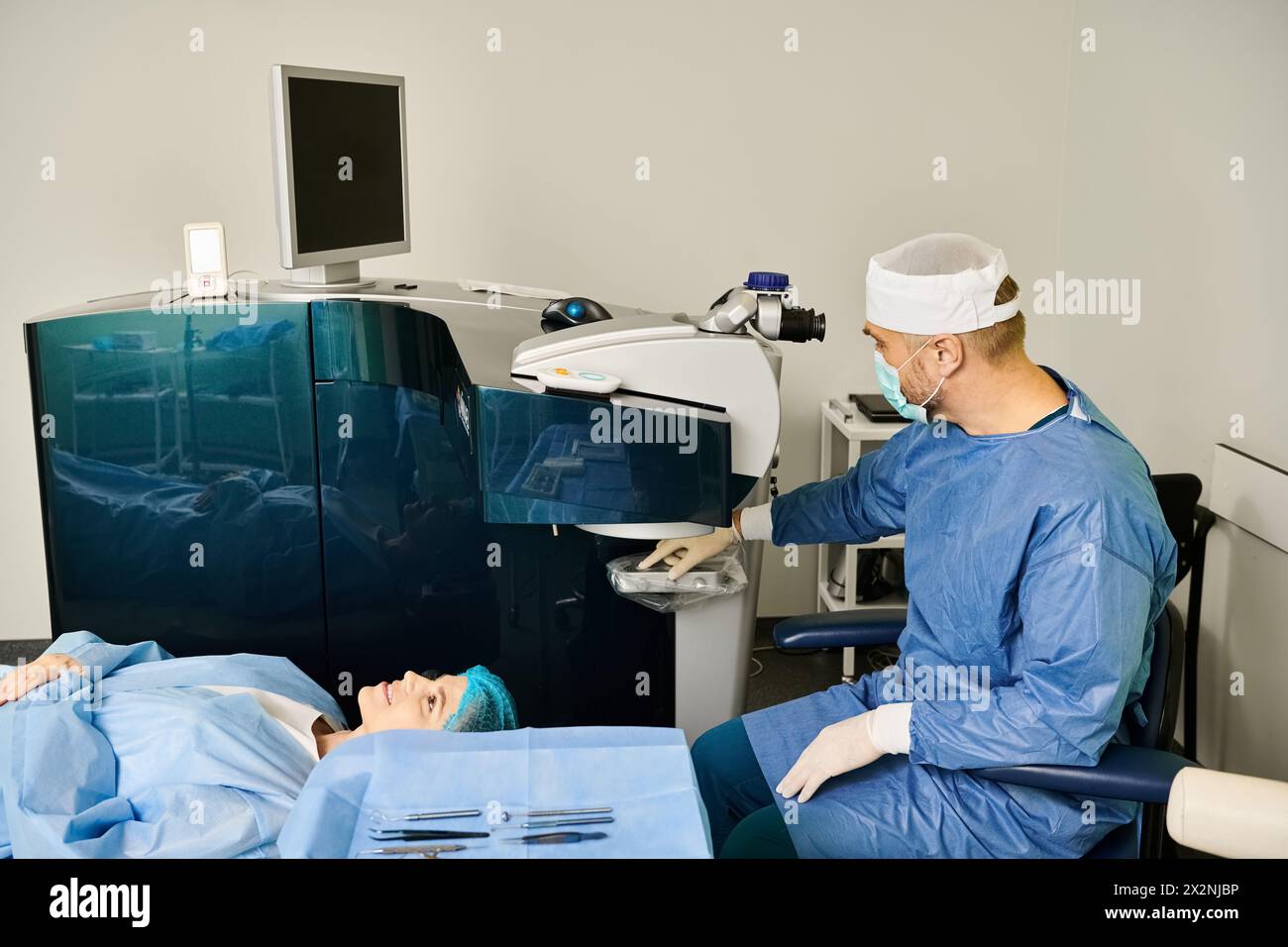 A person in a surgical gown operating a machine for laser vision ...