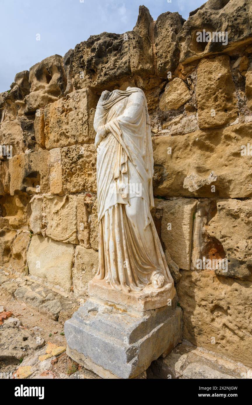 Marble statue under the sun rays and ancient columns at Salamis, Greek ...