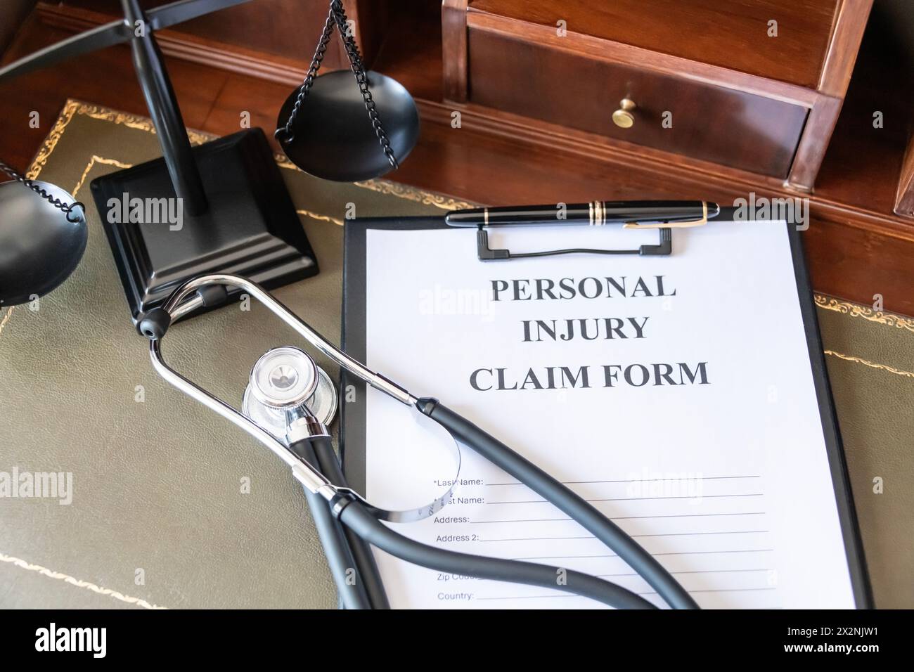 Legal Personal Injury Claim Form with Scales of Justice Stock Photo - Alamy