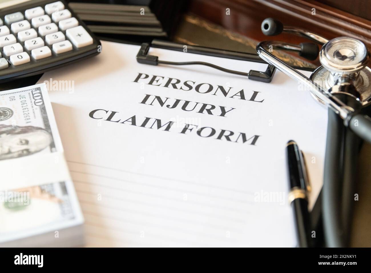 Close-up of a personal injury claim form with a stethoscope, calculator ...