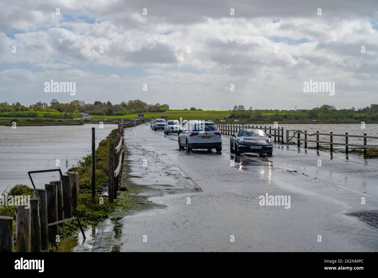 Traffic crossing The Strood to Mersea Island Essex. The causeway is ...