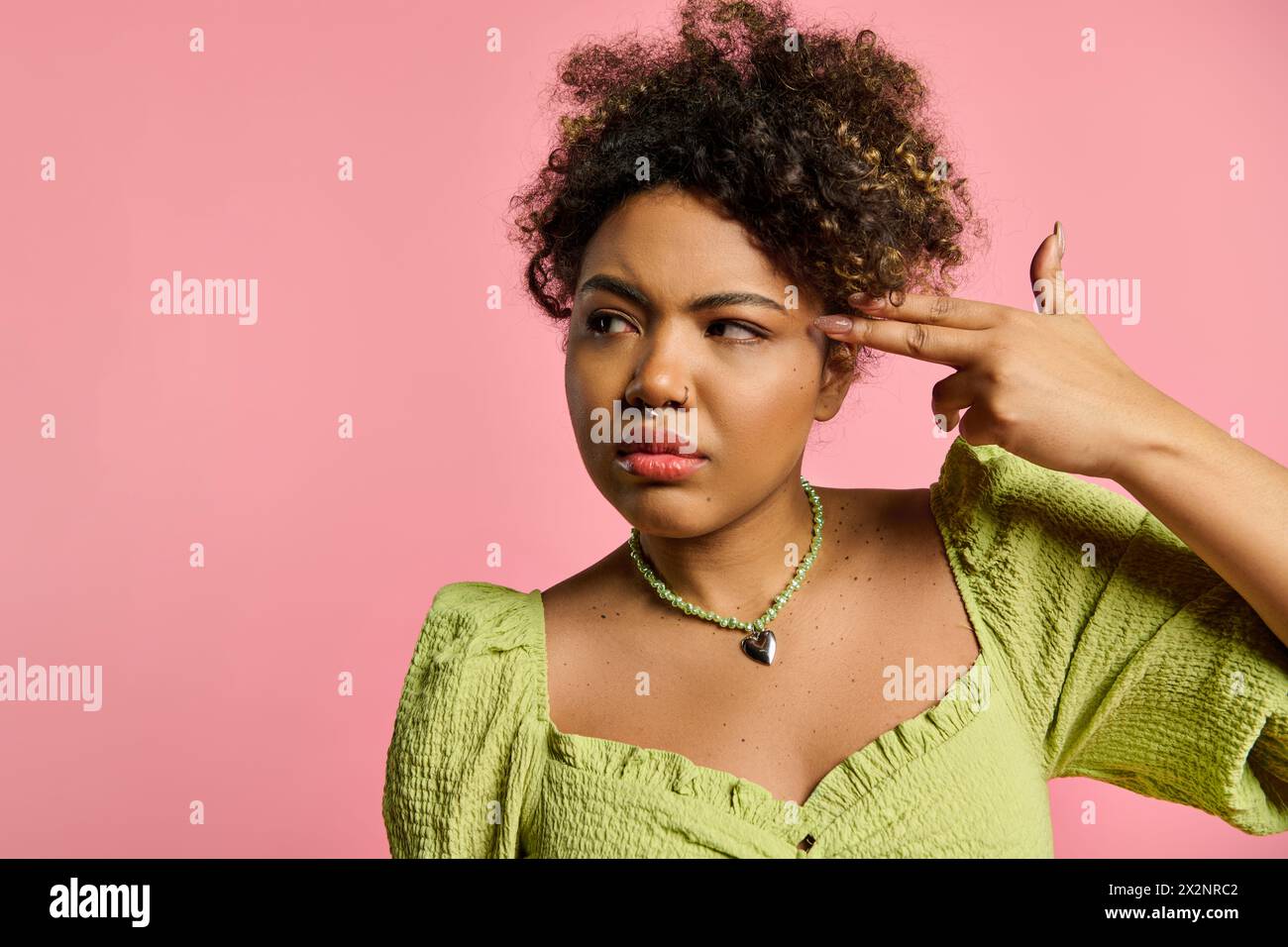 A stylish African American woman in a yellow top listens intently by ...
