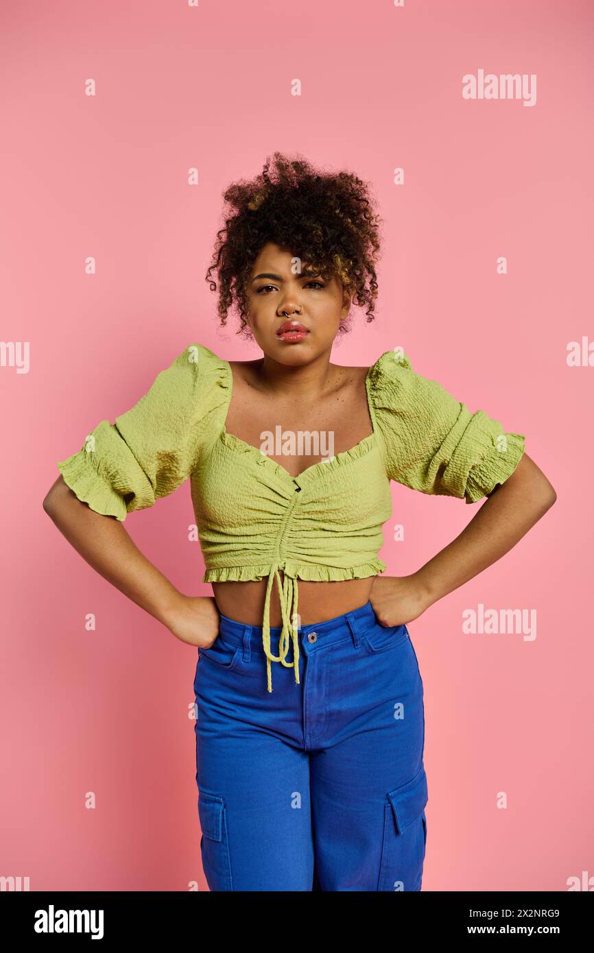 Stylish African American woman with hands on hips in dynamic pose Stock ...