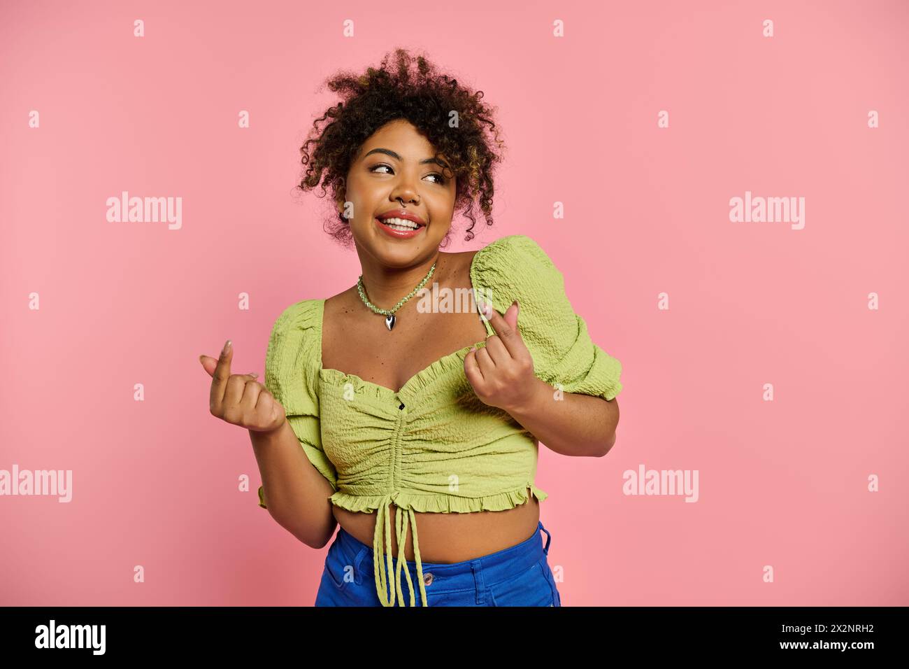 A stylish woman smiles with a playful pose Stock Photo - Alamy