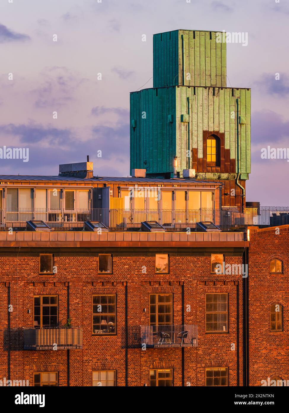 A tall building with a green tower on top of it, located in the city of Gothenburg, Sweden. The ...