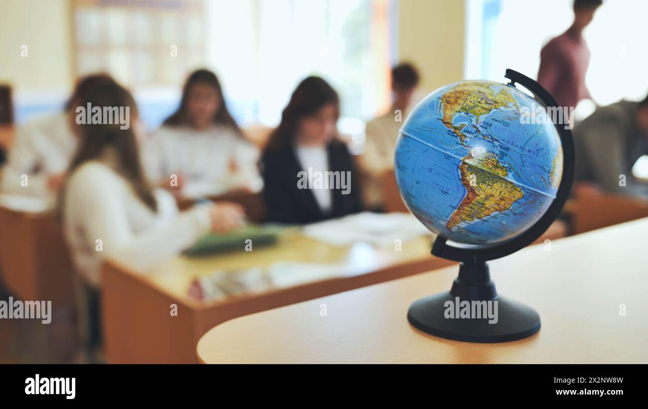 A globe of the world in a school classroom during a lesson. The globe ...