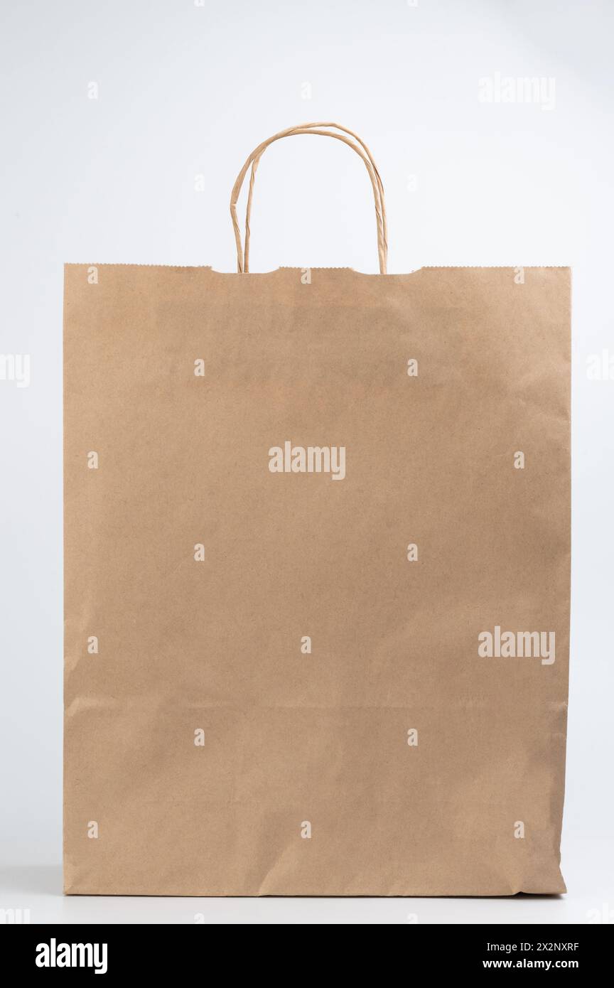 Clean empty brown paper bag with handles isolated on white studio ...