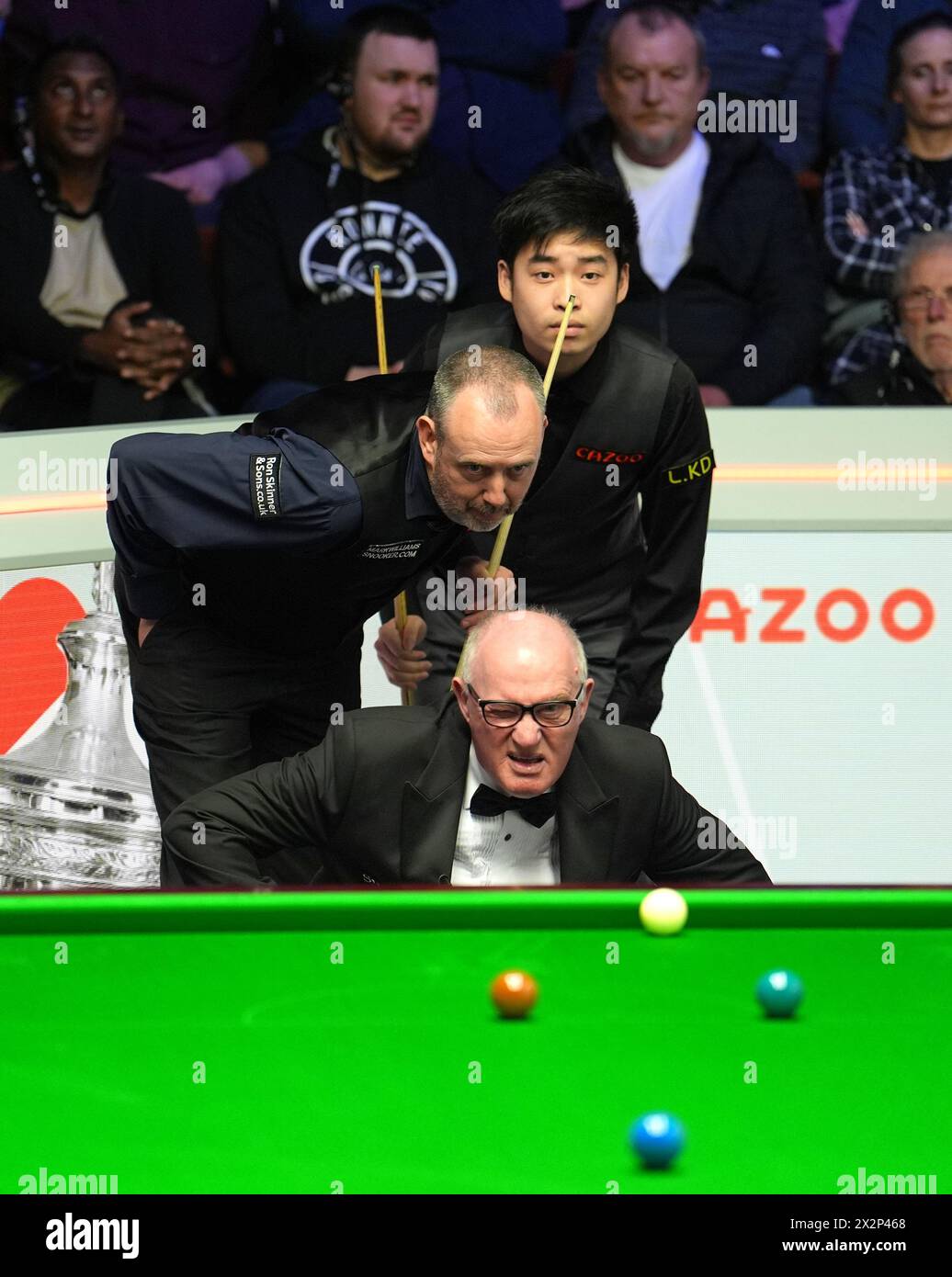 A referee checks the table during the match between Si Jiahui and Mark ...