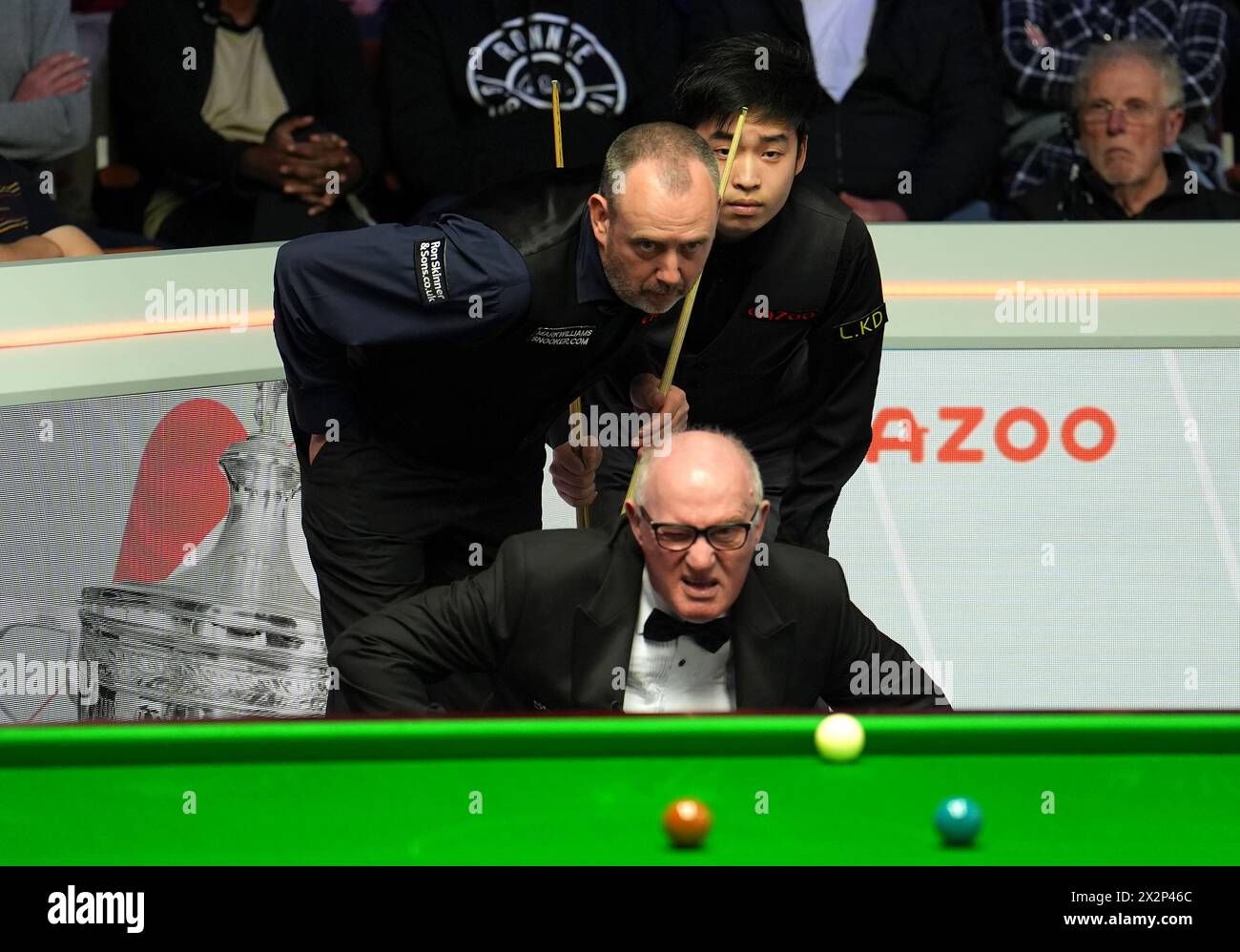 A referee checks the table during the match between Si Jiahui and Mark ...