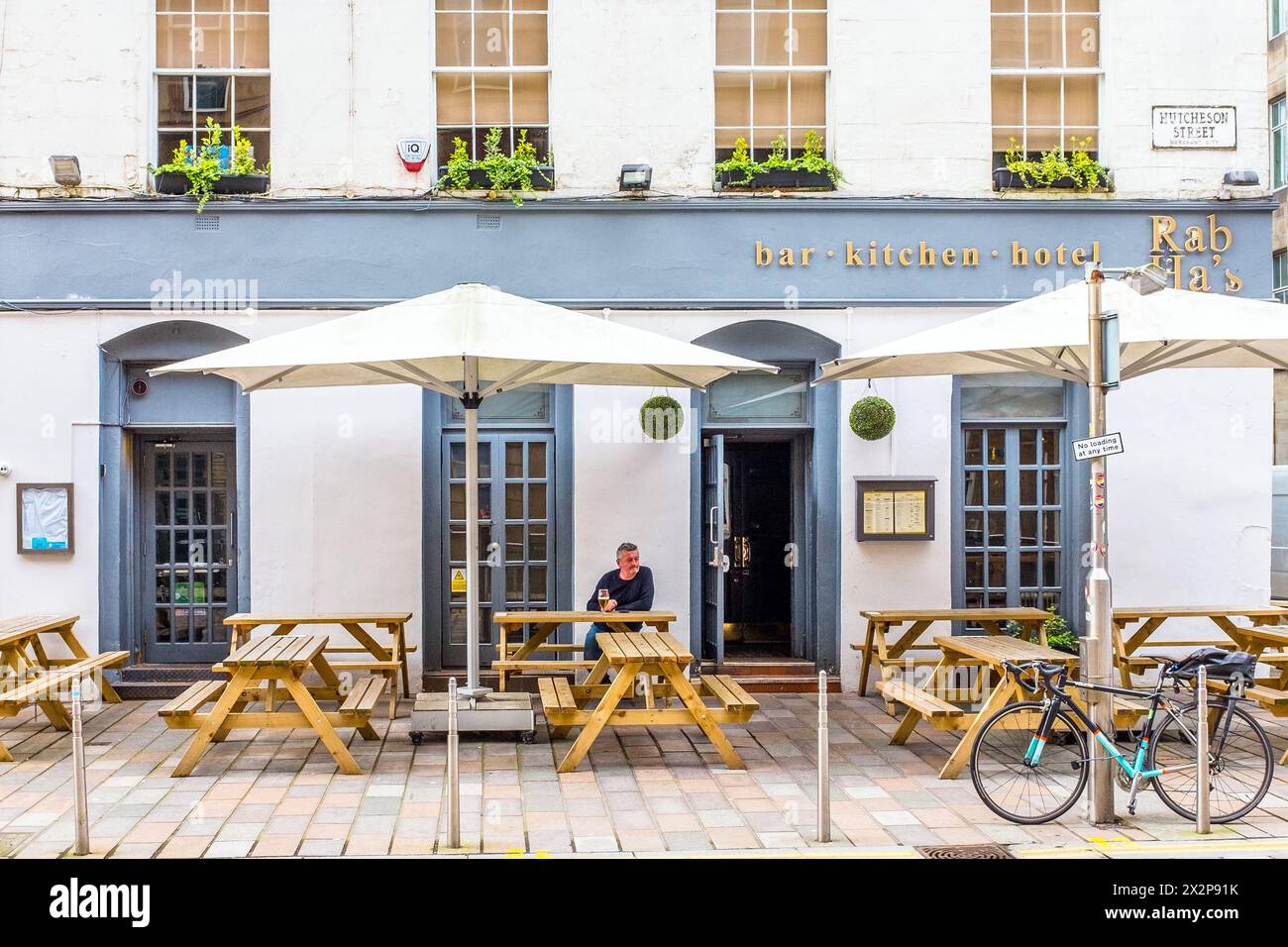 Man sitting alone with a beer, outside Rab' Ha public house in Merchant ...