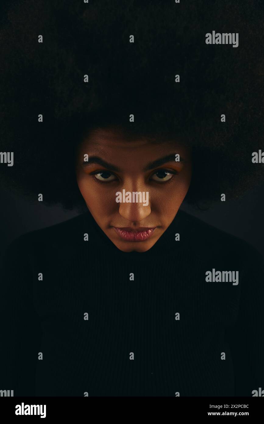 Trendy African American woman with large afro staring confidently at ...