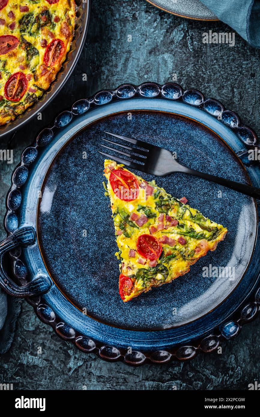 Homemade frittata with spinach, curd cheese, bacon, onion and green ...
