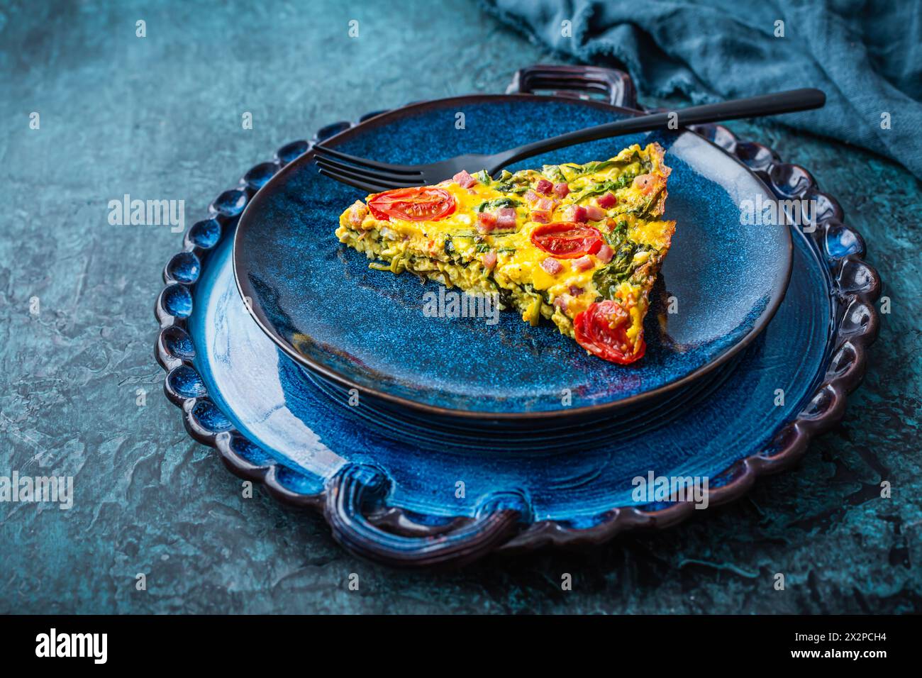 Homemade frittata with spinach, curd cheese, bacon, onion and green ...