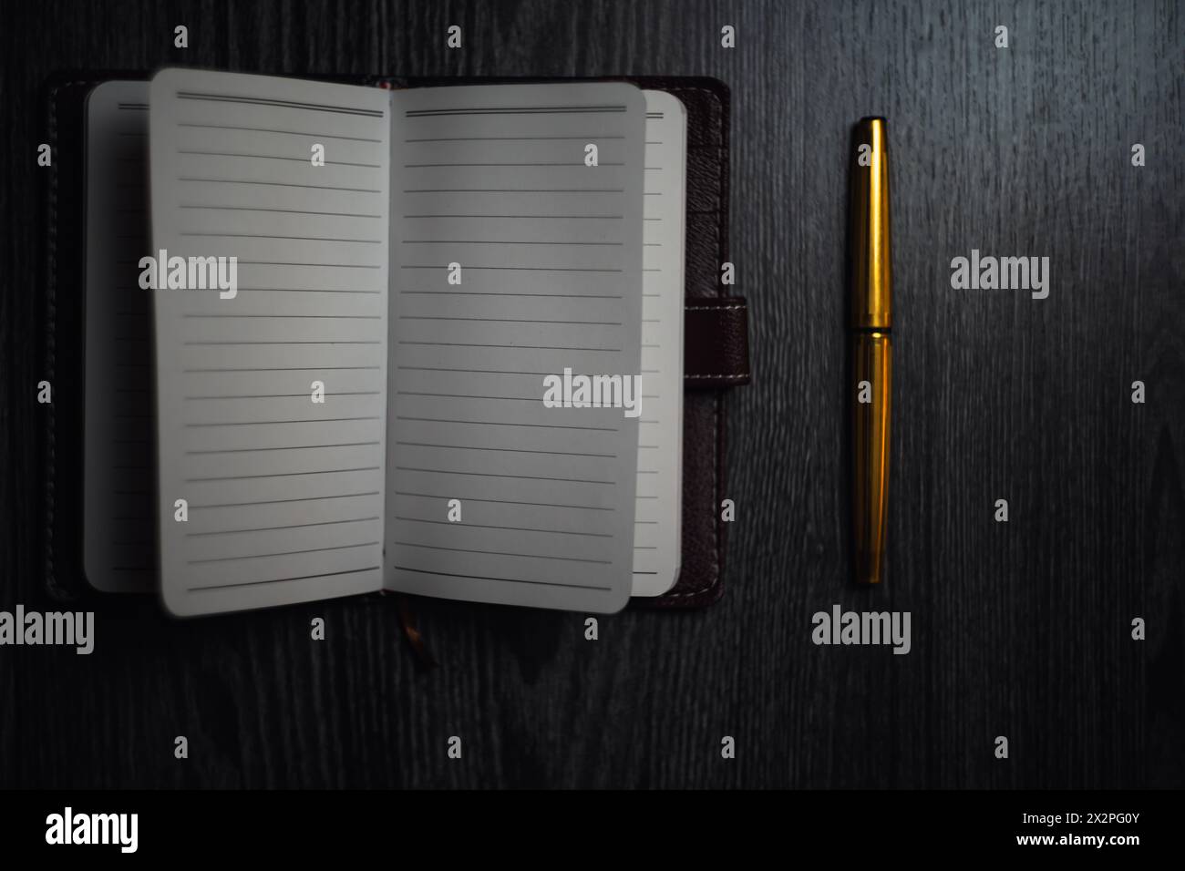 Subject shooting - Notepad and gold pen. Blank notepad on a darck wood ...