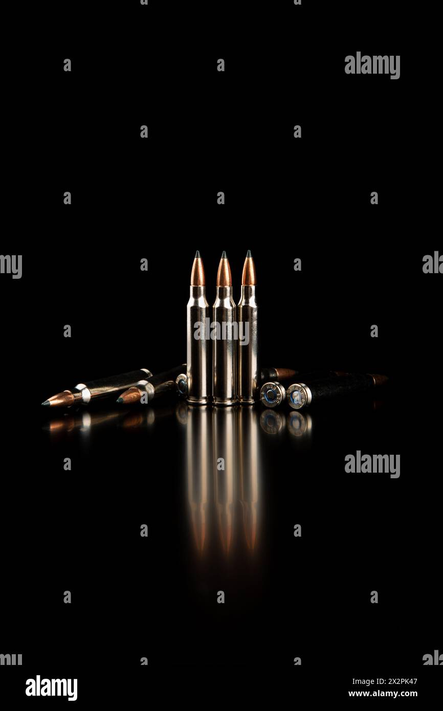 Bullet isolated on black background with reflexion. Rifle bullets close ...