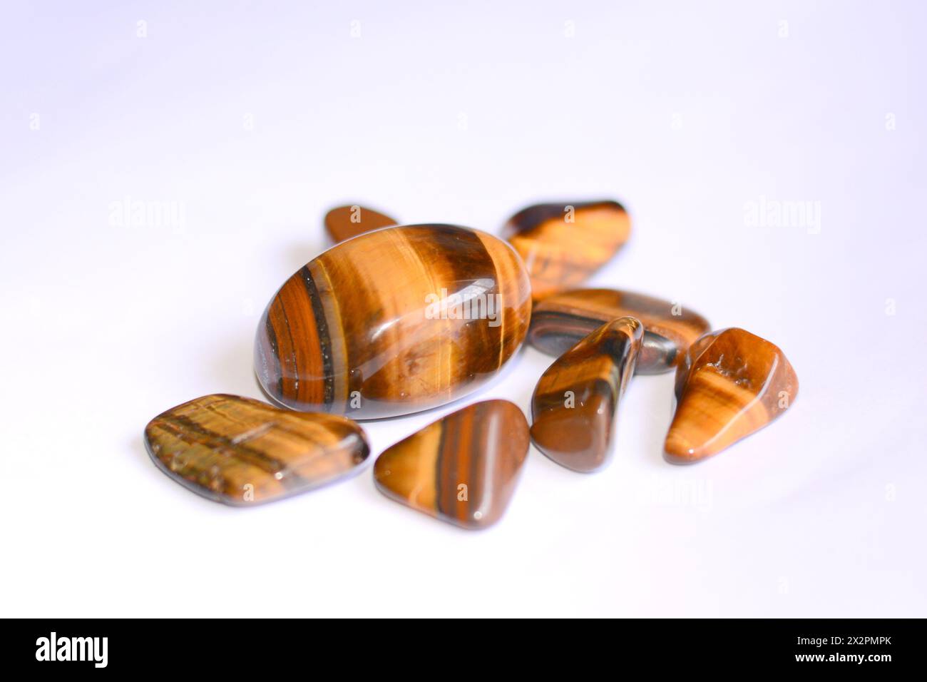 A collection of raw tiger's eye gemstones, showcasing their natural ...