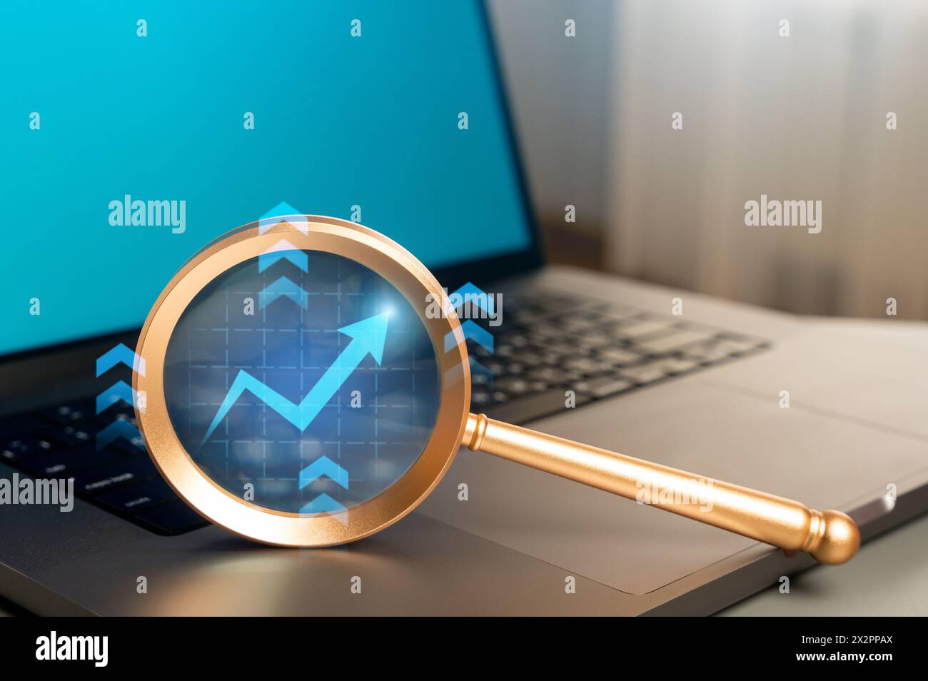 Growth and success arrow on a magnifying glass near a laptop. Growth of ...