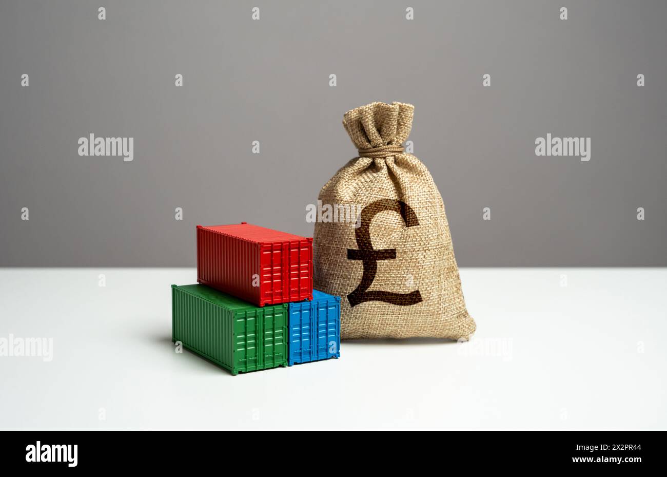 Stack of shipping containers and british pound sterling money bag ...