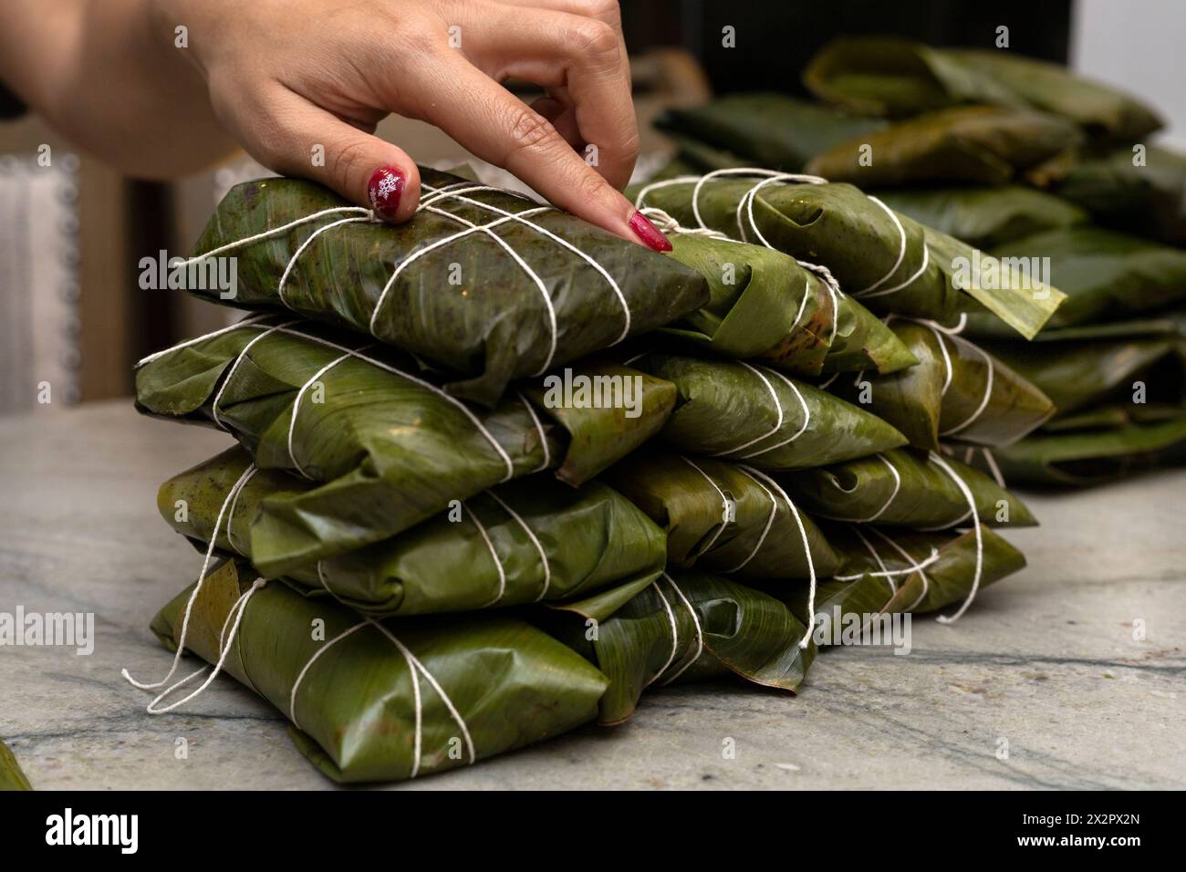 Hallaca or tamale wrapped in banana leaf. Traditional food Stock Photo ...