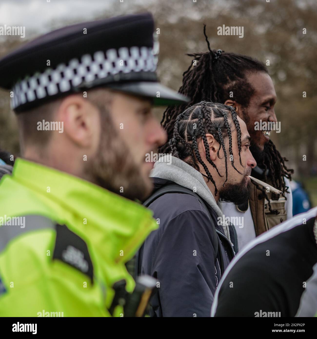A police officer and a man with a large cannabis joint during the 420 ...
