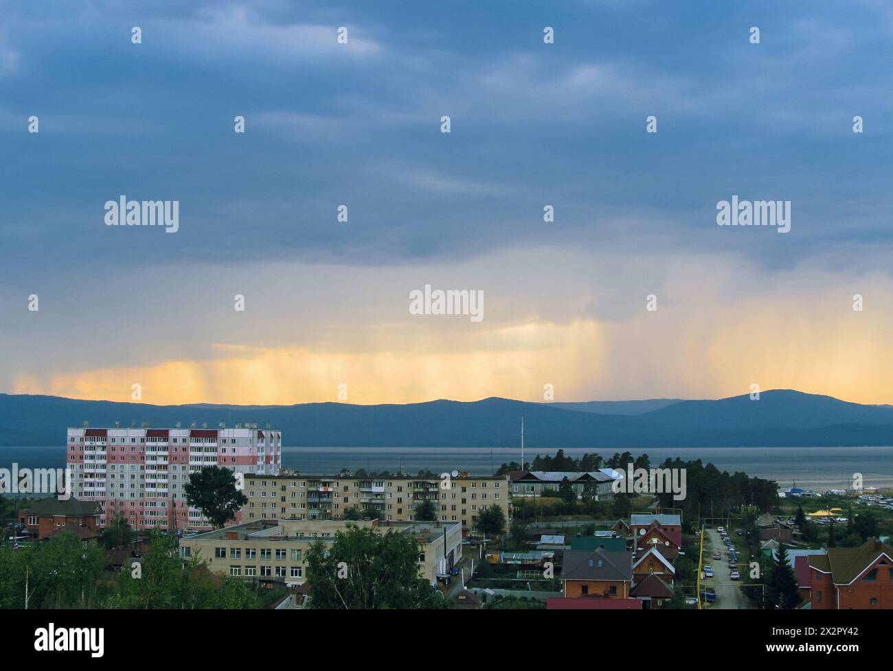 Residential houses and buildings against the backdrop of a lake and ...