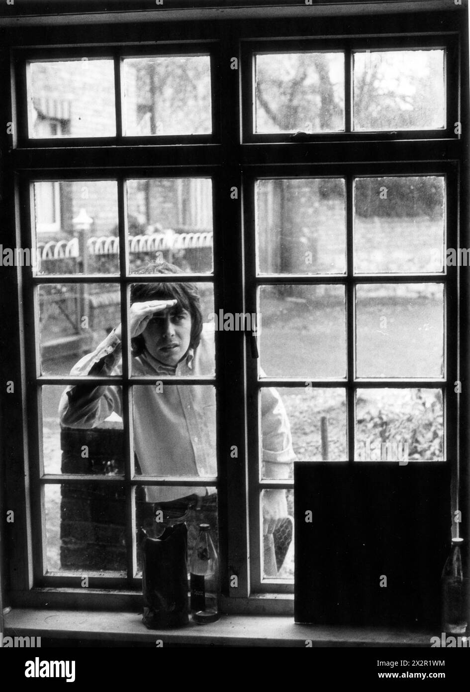 Home security man peering through window 1972 Stock Photo - Alamy