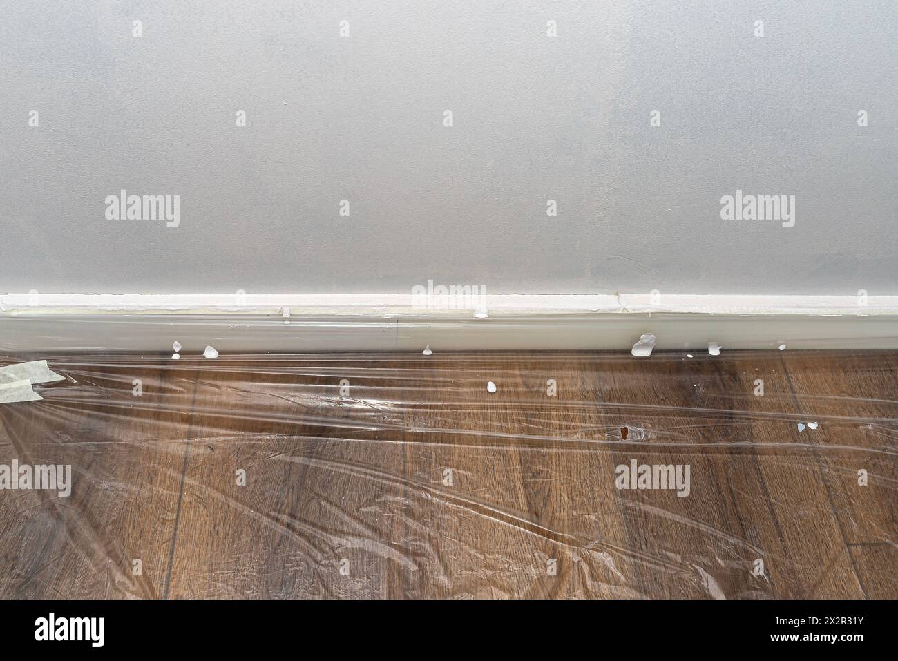 The vinyl floor is protected with foil before painting and covered with ...