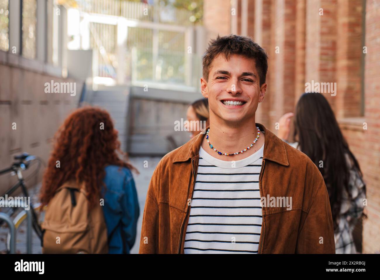 Portrait of one student teenage male smiling and looking at camera at ...